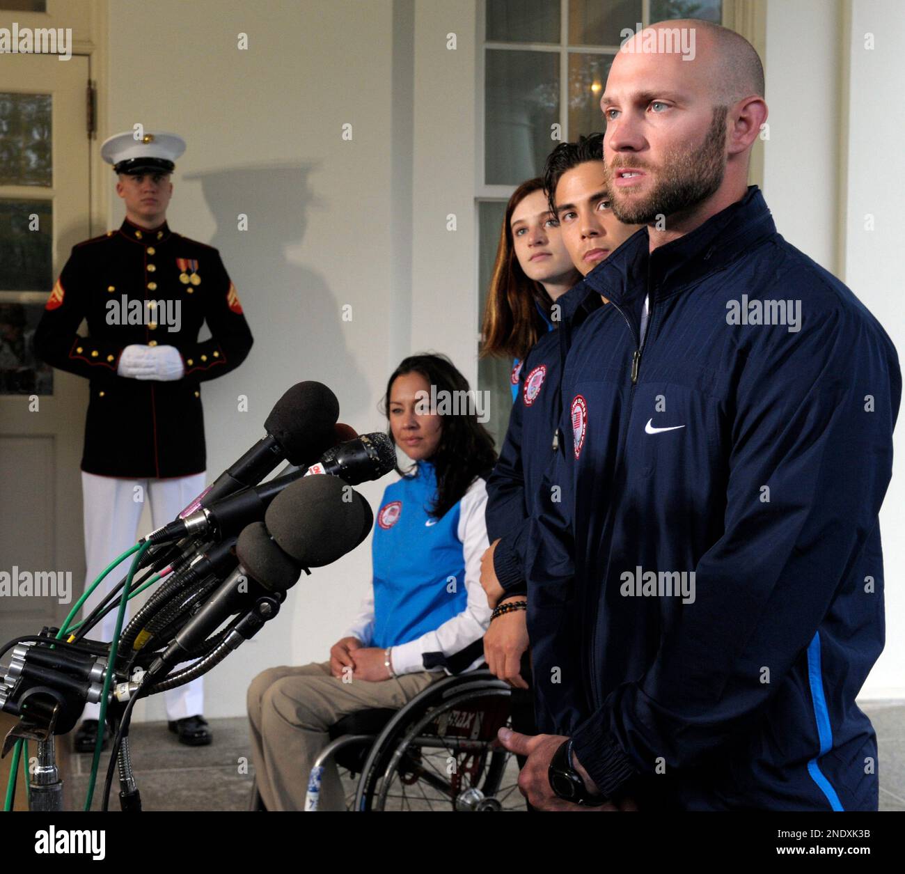 Paralympian alpine sit skier Heath Calhoun, right, speaks to the media ...