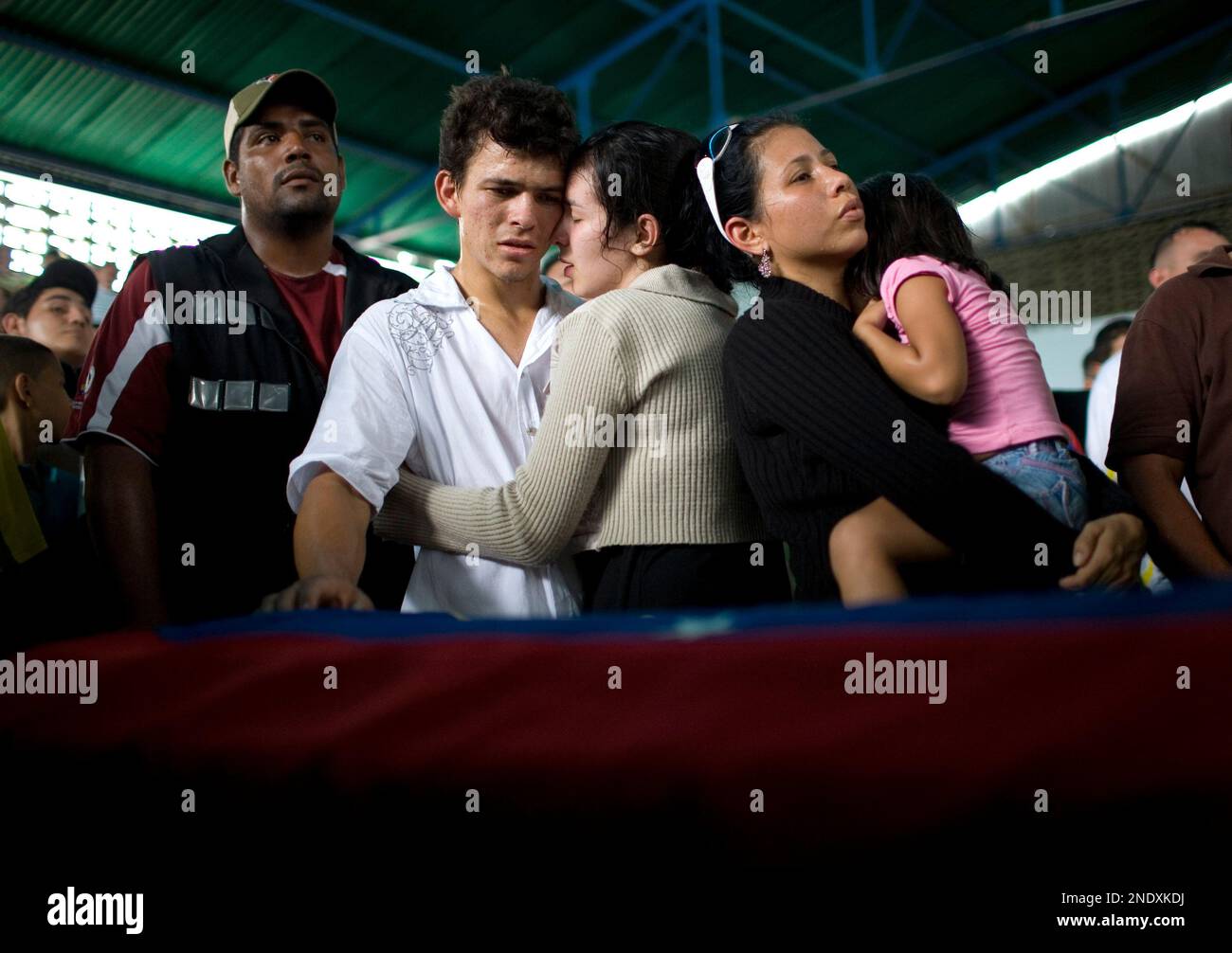 People mourn by the coffin of former boxing champion Edwin Valero ...