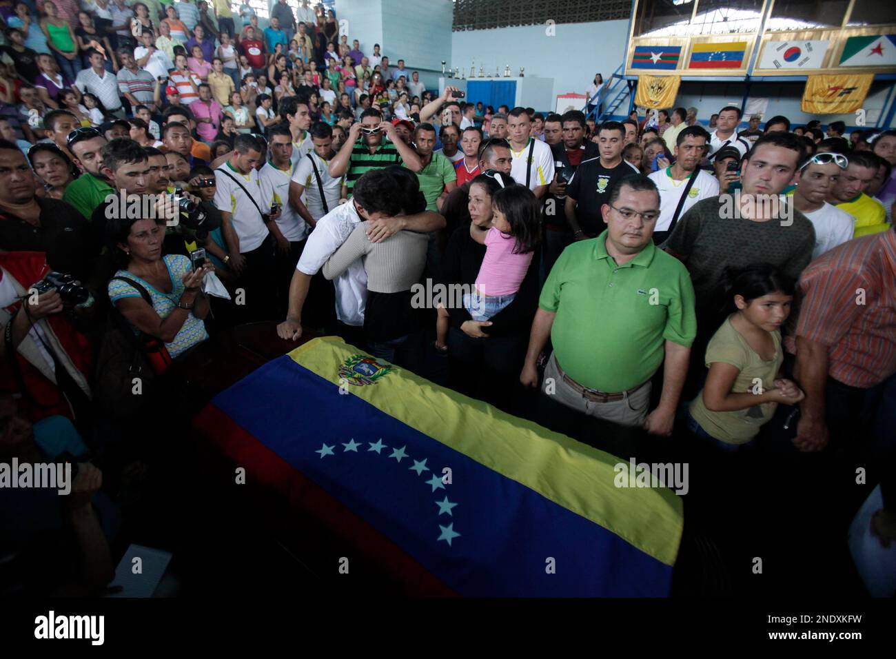 People gather around the Venezuelan flag covered coffin of former ...