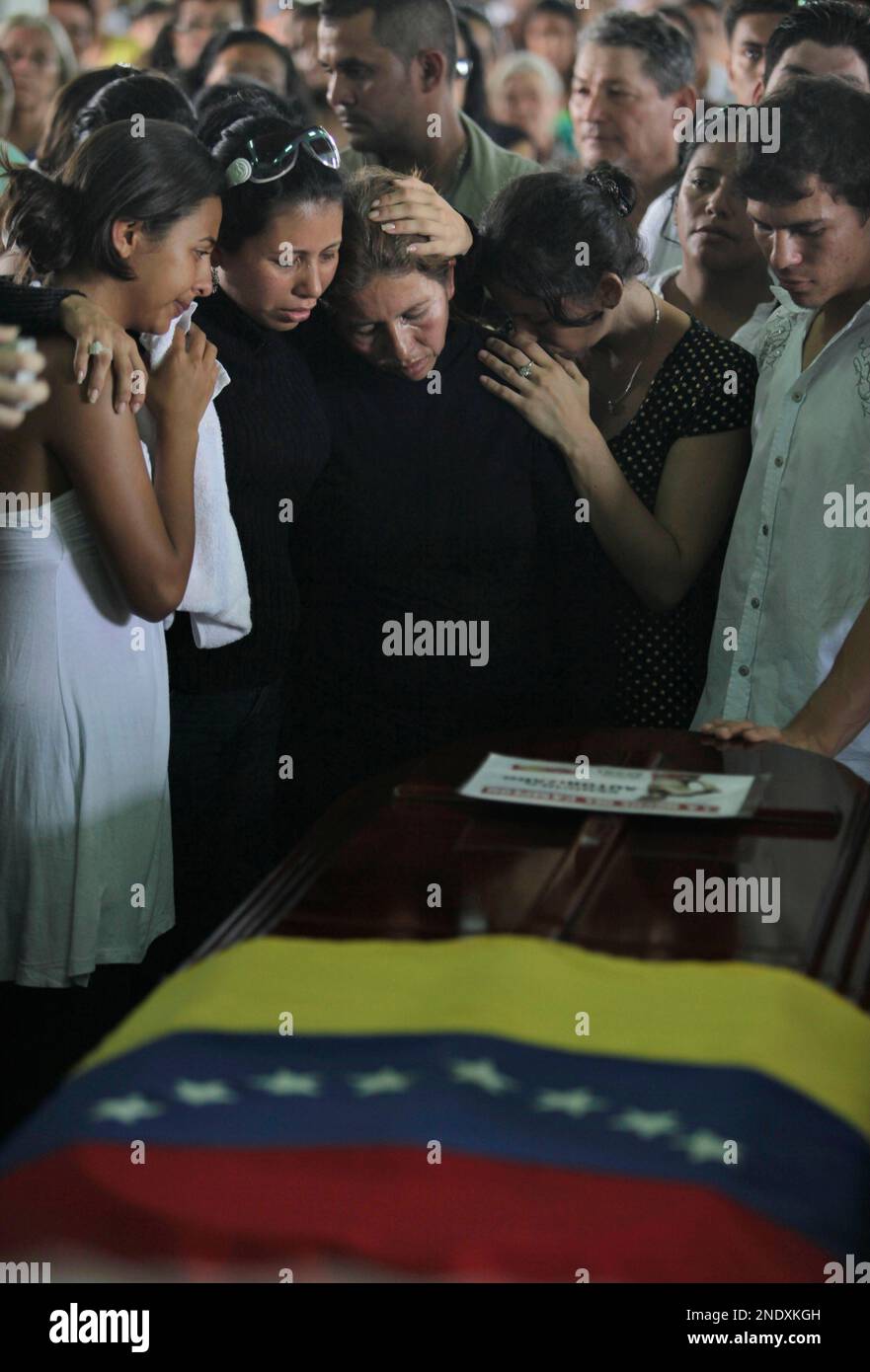 Relatives mourn during the funeral of former world boxing champion ...