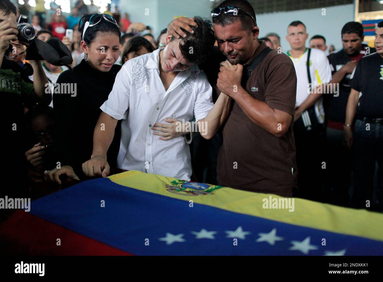 Relatives mourn over the coffin of former boxing champion Edwin Valero ...