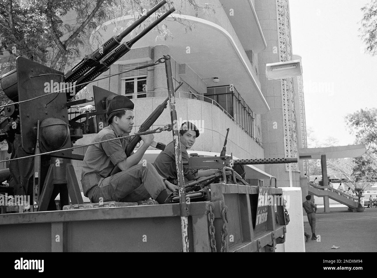 Vietnamese soldiers man anti-aircraft and machine guns on truck outside ...