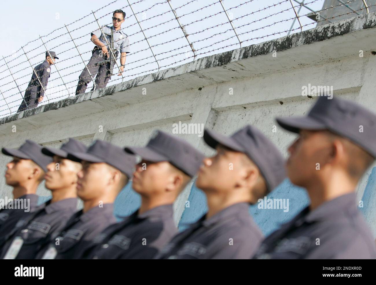 A guard patrols the walls of a maximum-security jail during the ...