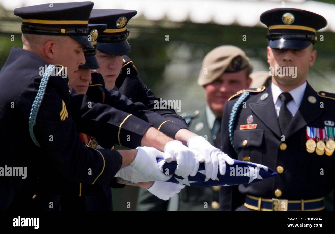 Members of the U.S. Army's Old Guard pass the flag of Army Cpl. Michael ...