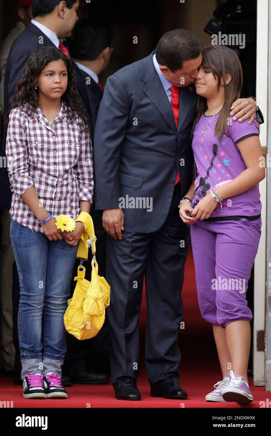 Venezuela's President Hugo Chavez, center, kisses his daughter Rosaines ...