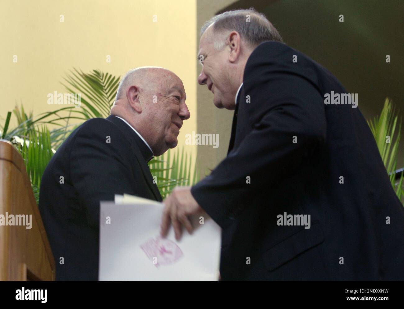 Miami Archbishop John Favalora, left, shakes hands with Bishop Thomas ...