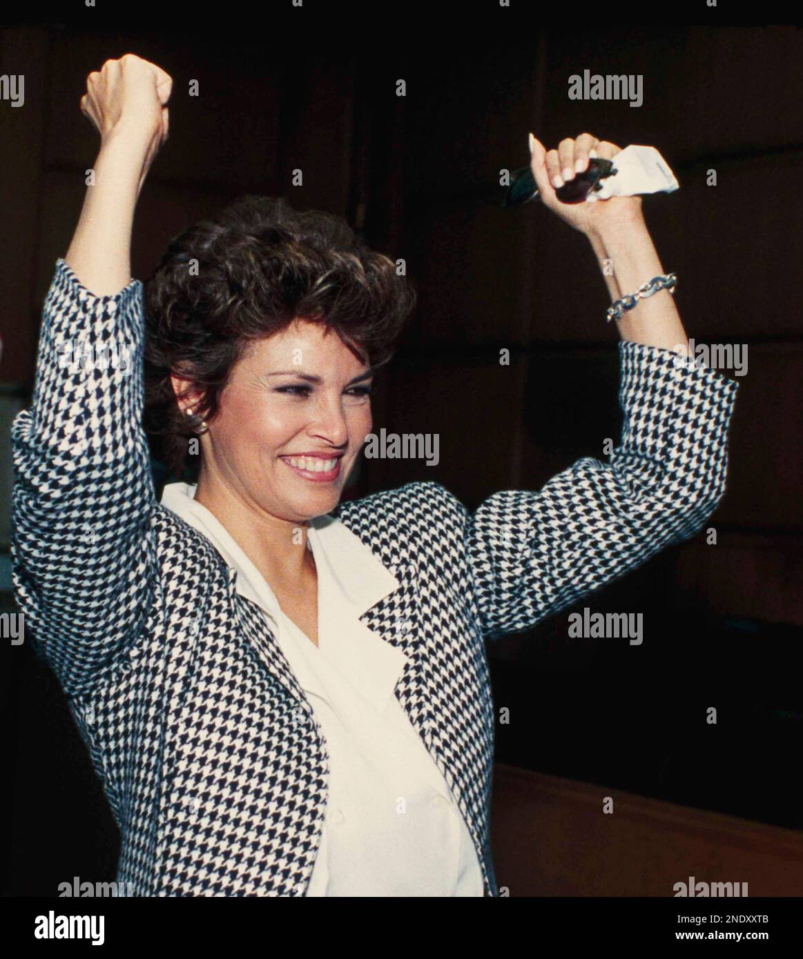 Actress Raquel Welch raises her arms in victory in Los Angeles, Tuesday ...