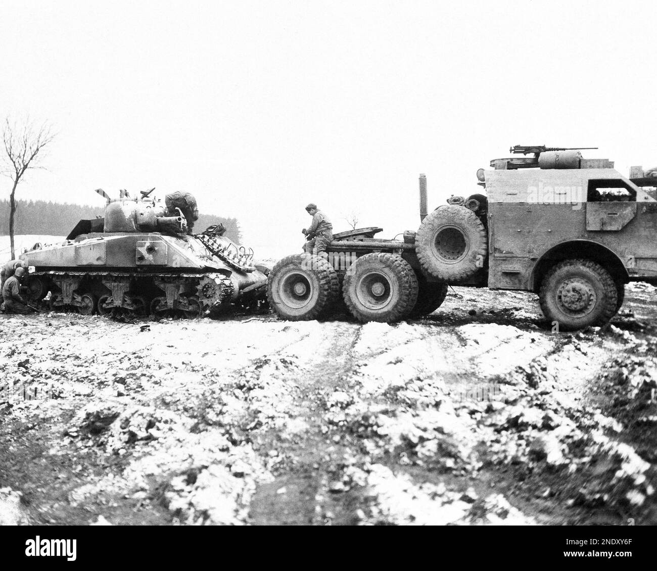 Crew of tank retriever prepares to haul out an M-4 that was put out of ...