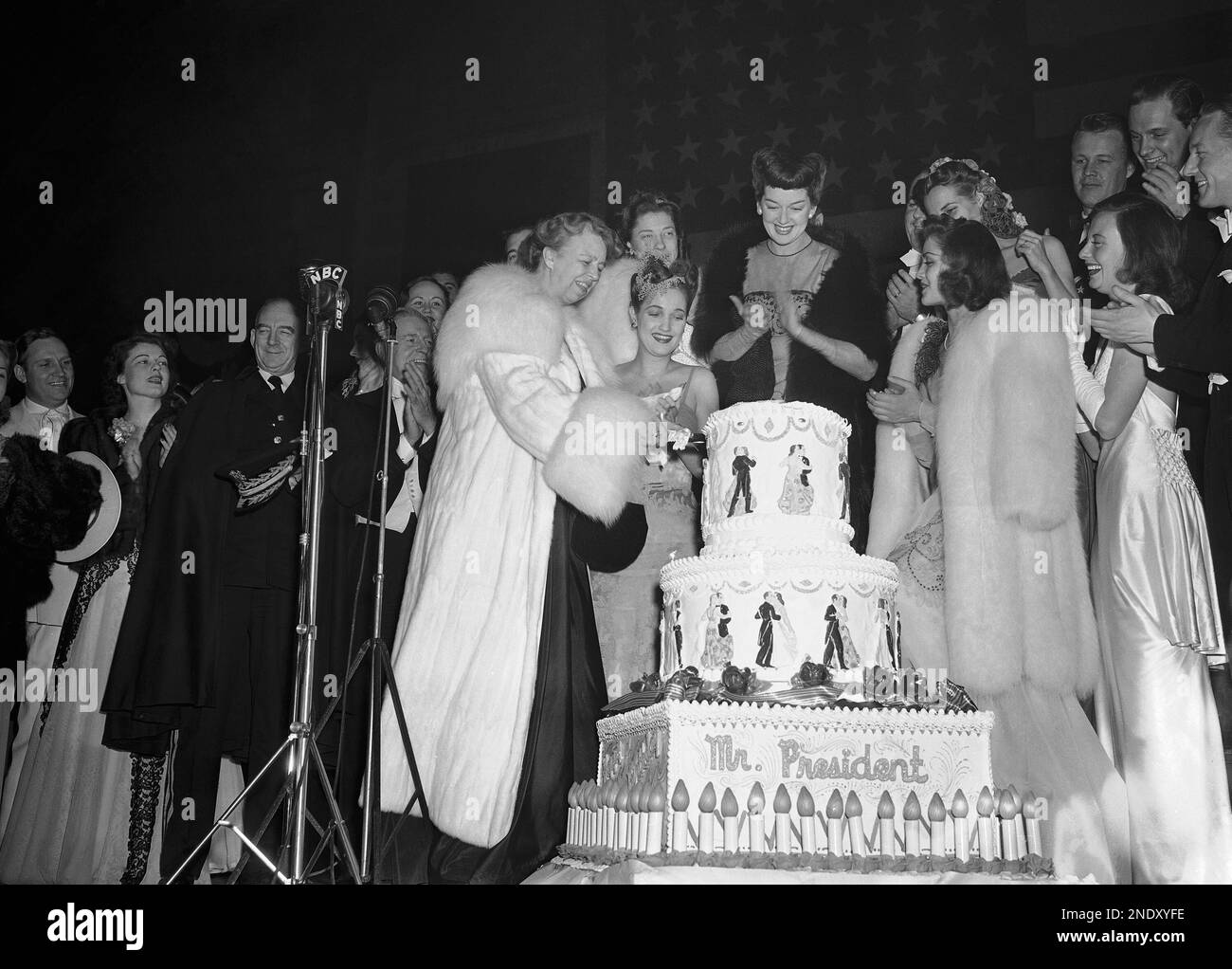 Mrs. Franklin D. Roosevelt cuts the President’s birthday cake at a ...