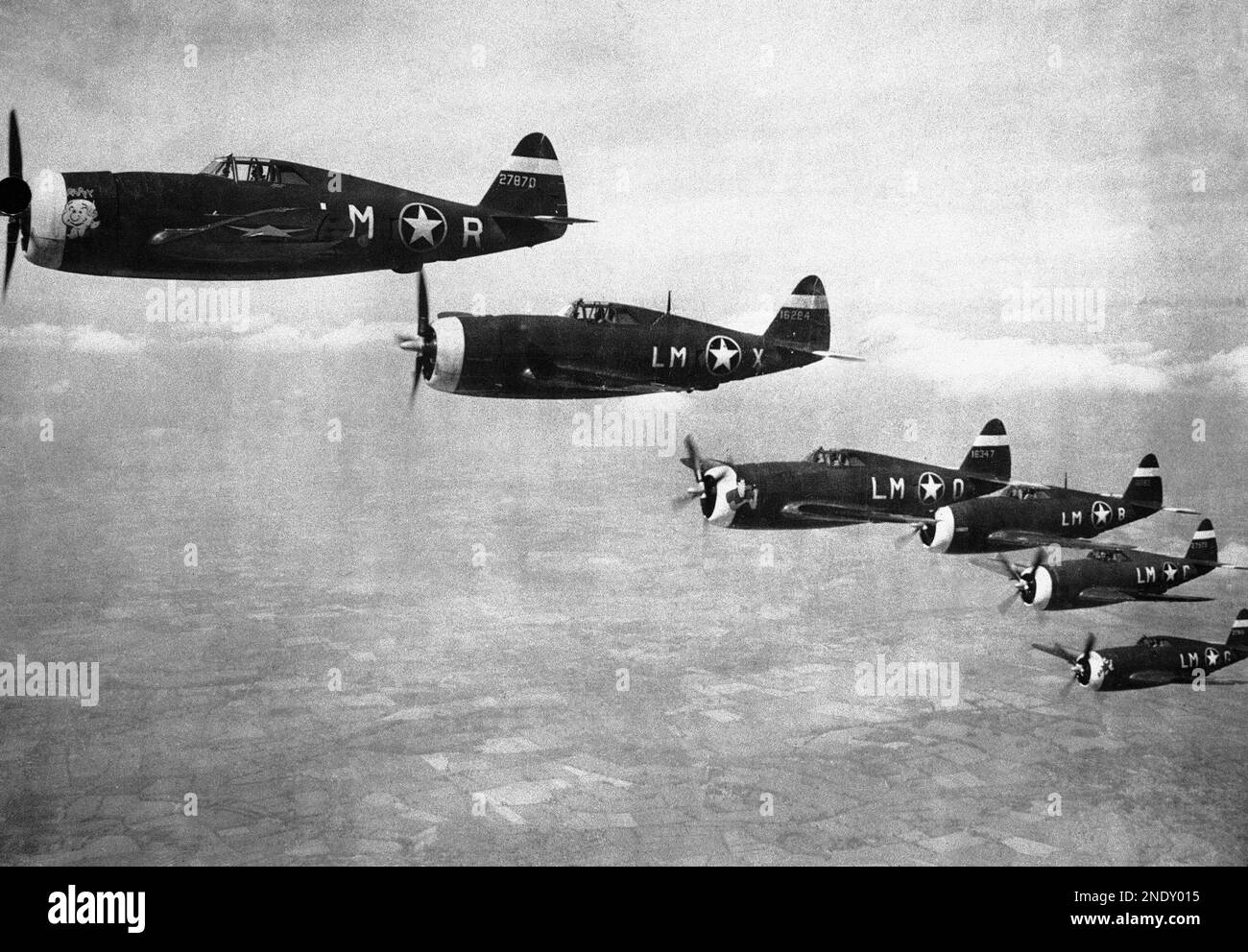 An echelon formation of American P-47 Thunderbolts in flight somewhere ...