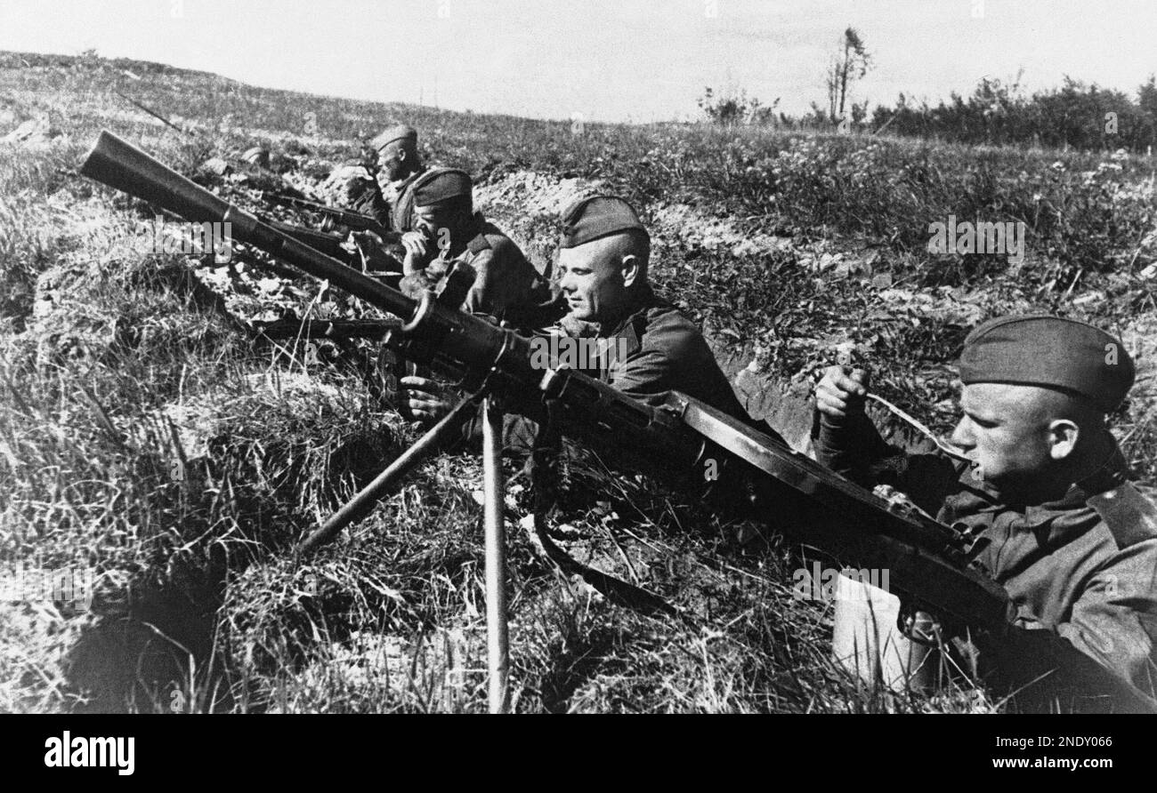 Russian soldiers in trenches on the Kalinin front on August 16, 1943, are forced to eat whilst ...
