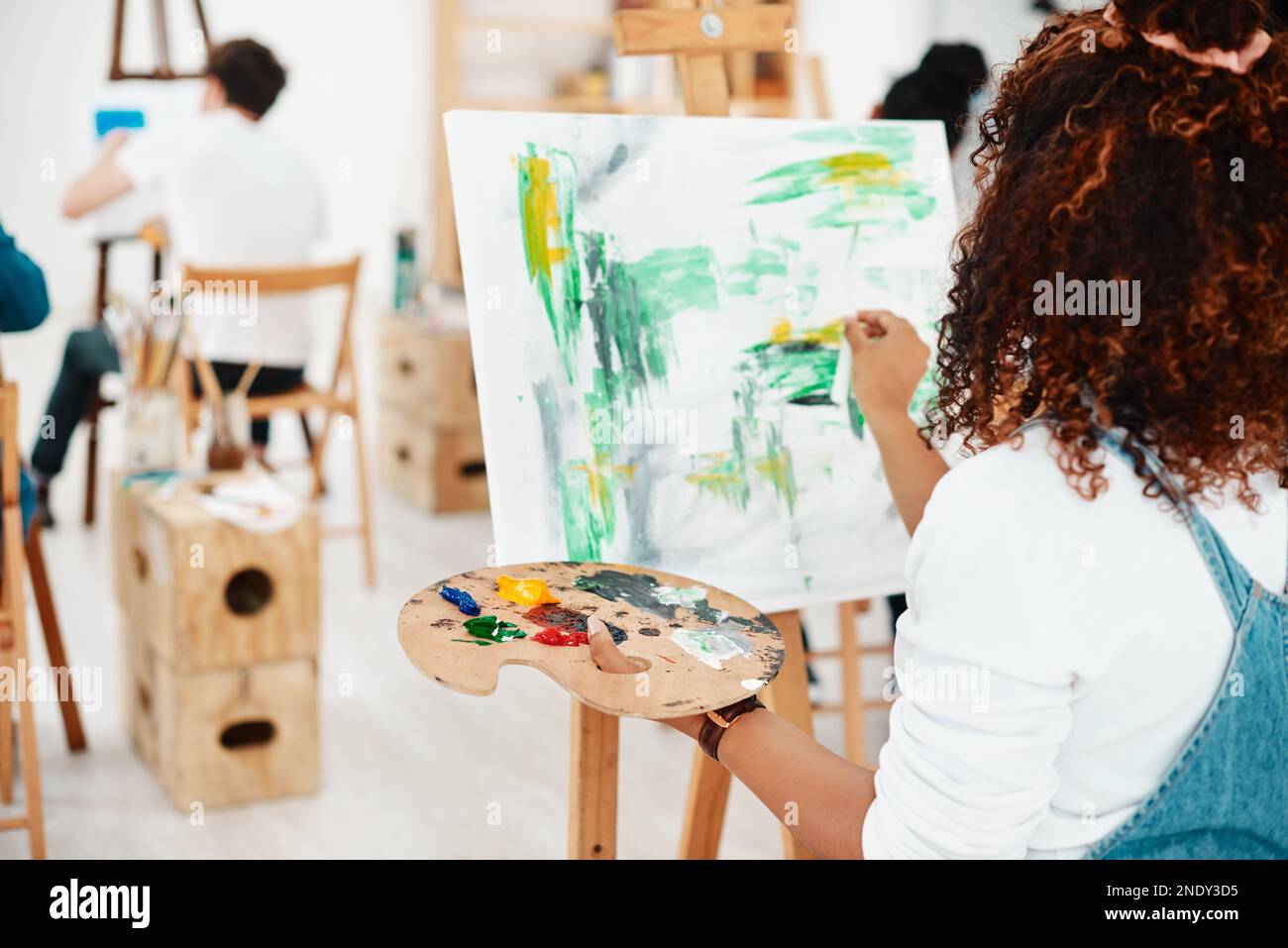 Abstract paintings are her favourite. an unrecognizable artist sitting ...