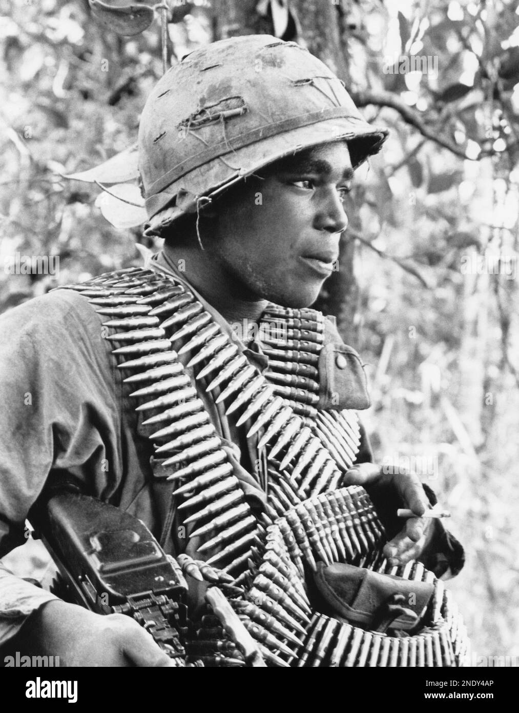 Bands of M60 ammunition hang around the shoulders of SP/4 Carl Napiel ...