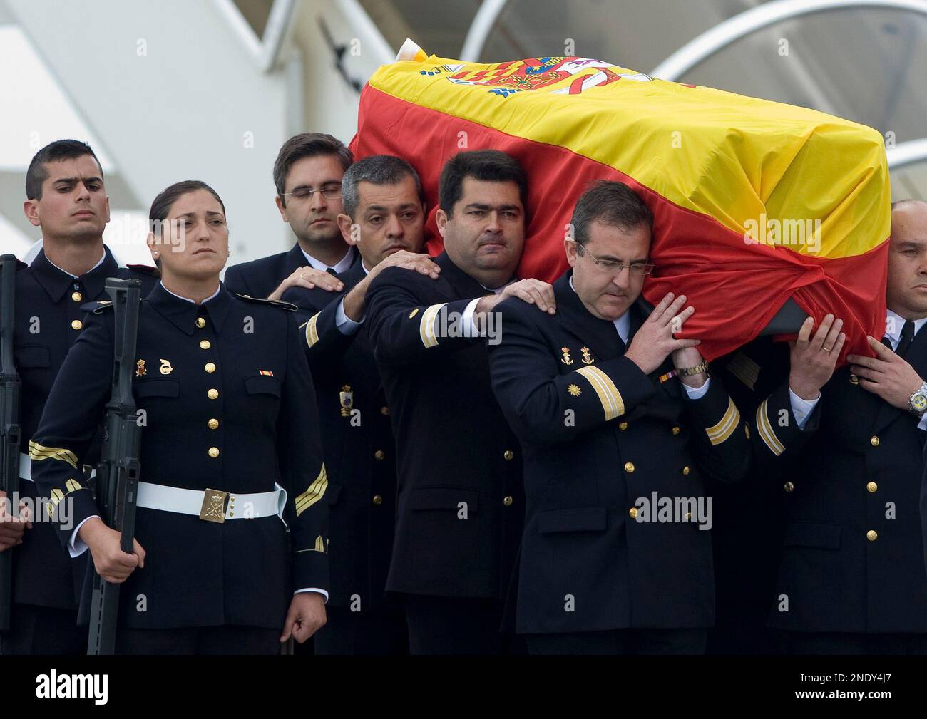 Spanish soldiers carry the coffin of one of four soldiers who died in a ...