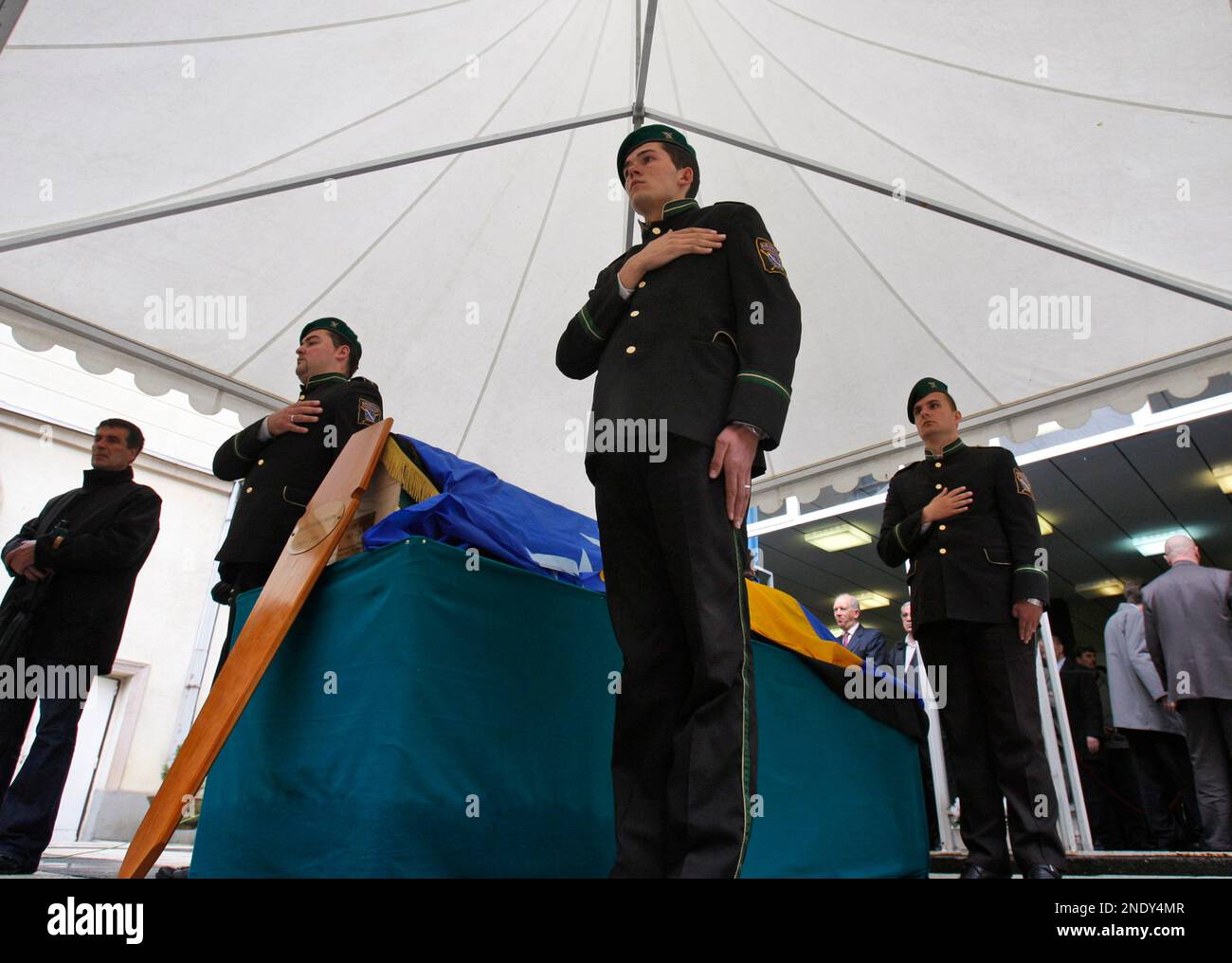 Bosnian people pay their respects next to the coffin of former Bosnian ...