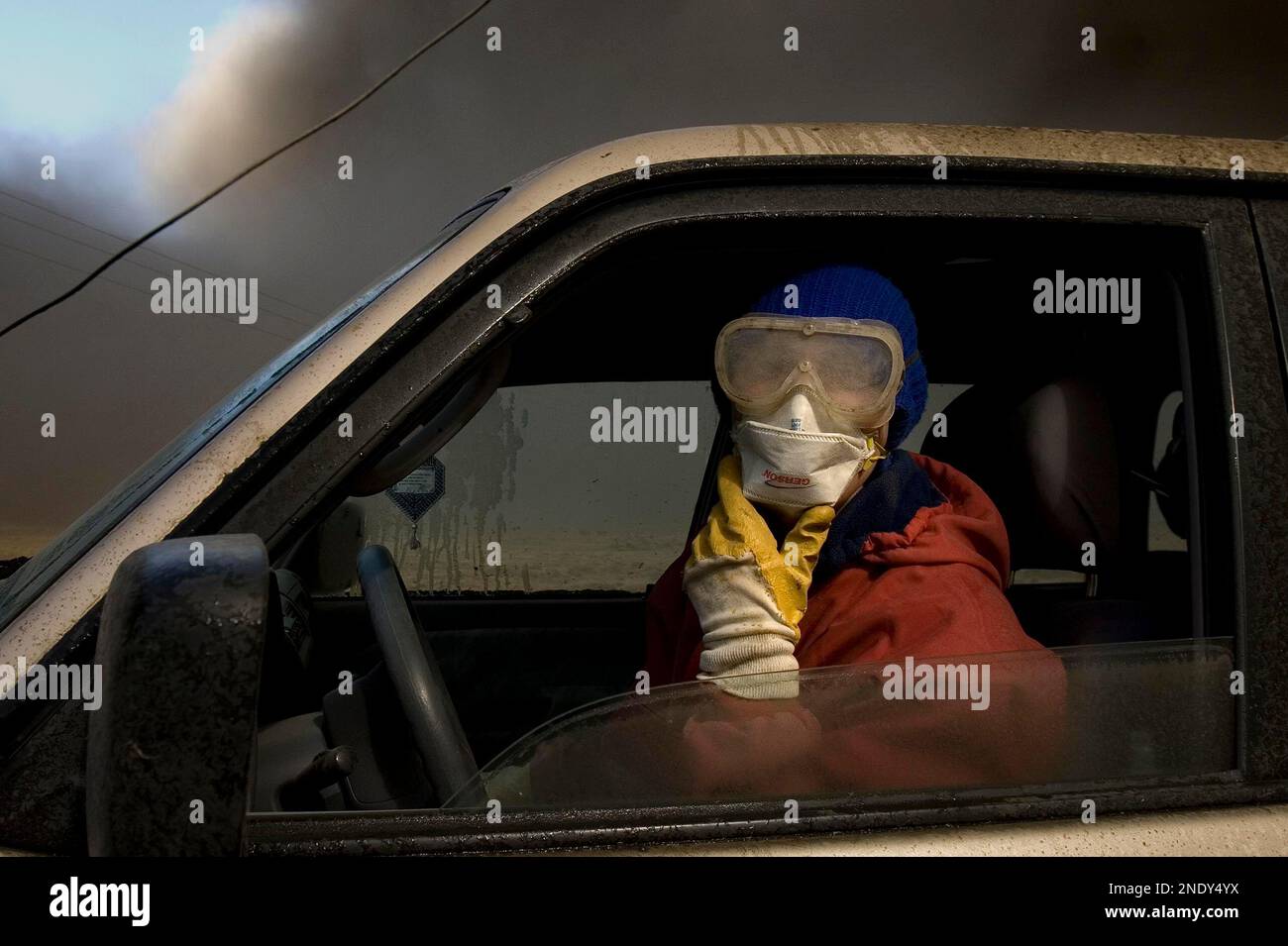 Wearing a mask and glasses against the smoke, dairy farmer Berglind ...