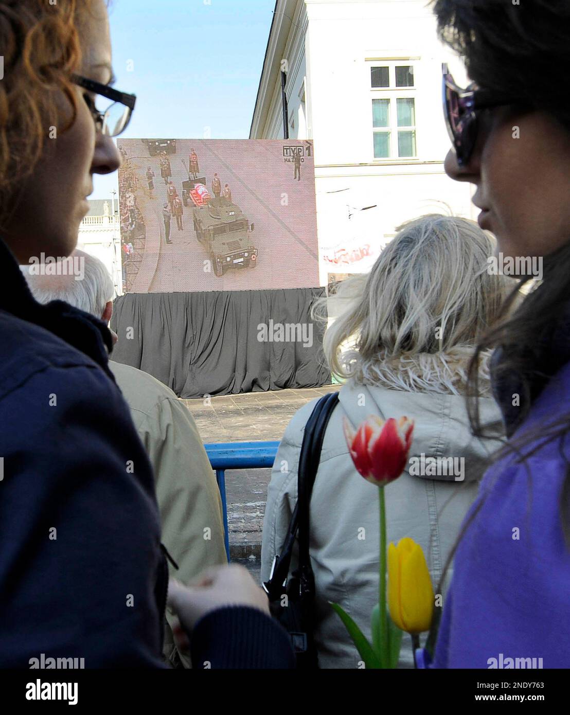 People watch the broadcast of the funeral on Sunday, April 18, 2010 in ...