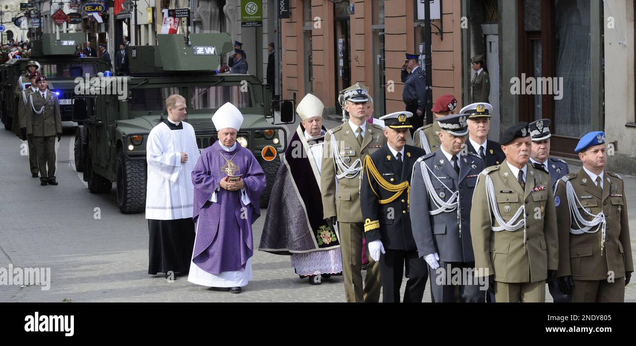 Polish Army generals and priests walk in front of military vehicles ...