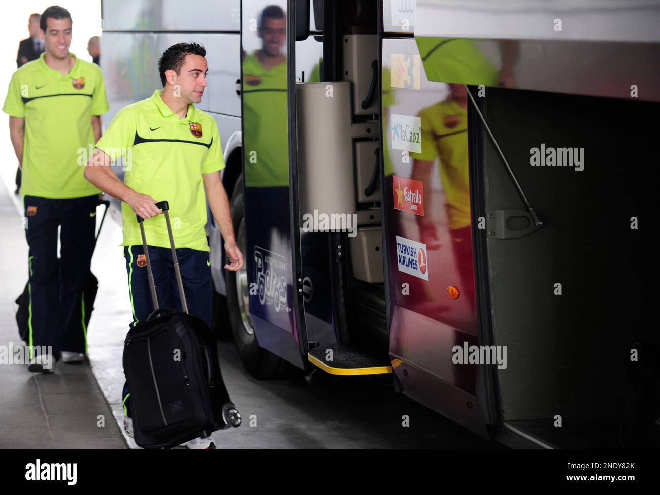 FC Barcelona's Xavi Hernandez gets on the team bus before the trip to ...