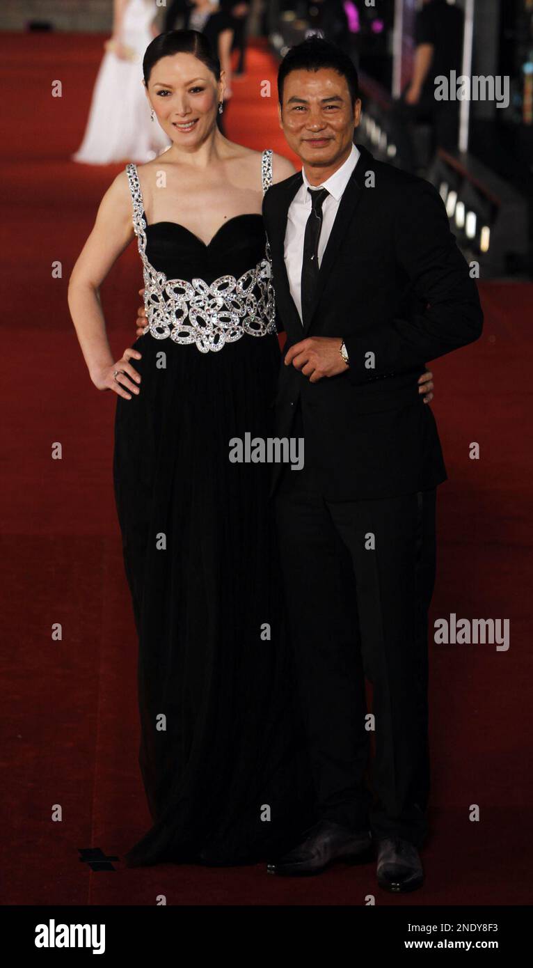 Hong Kong's actor Simon Yam, right and his wife Qiqi pose on the red ...