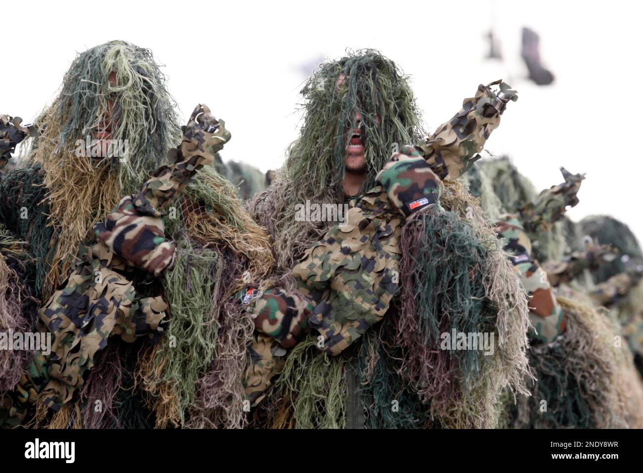 Wearing ghilli suits, Iranian army soldiers march during a parade marking National Army Day, in ...