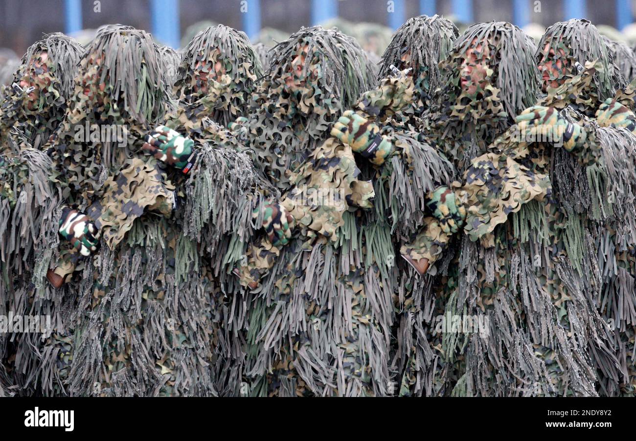 Wearing ghilli suits, Iranian army soldiers march during a parade marking National Army Day, in ...