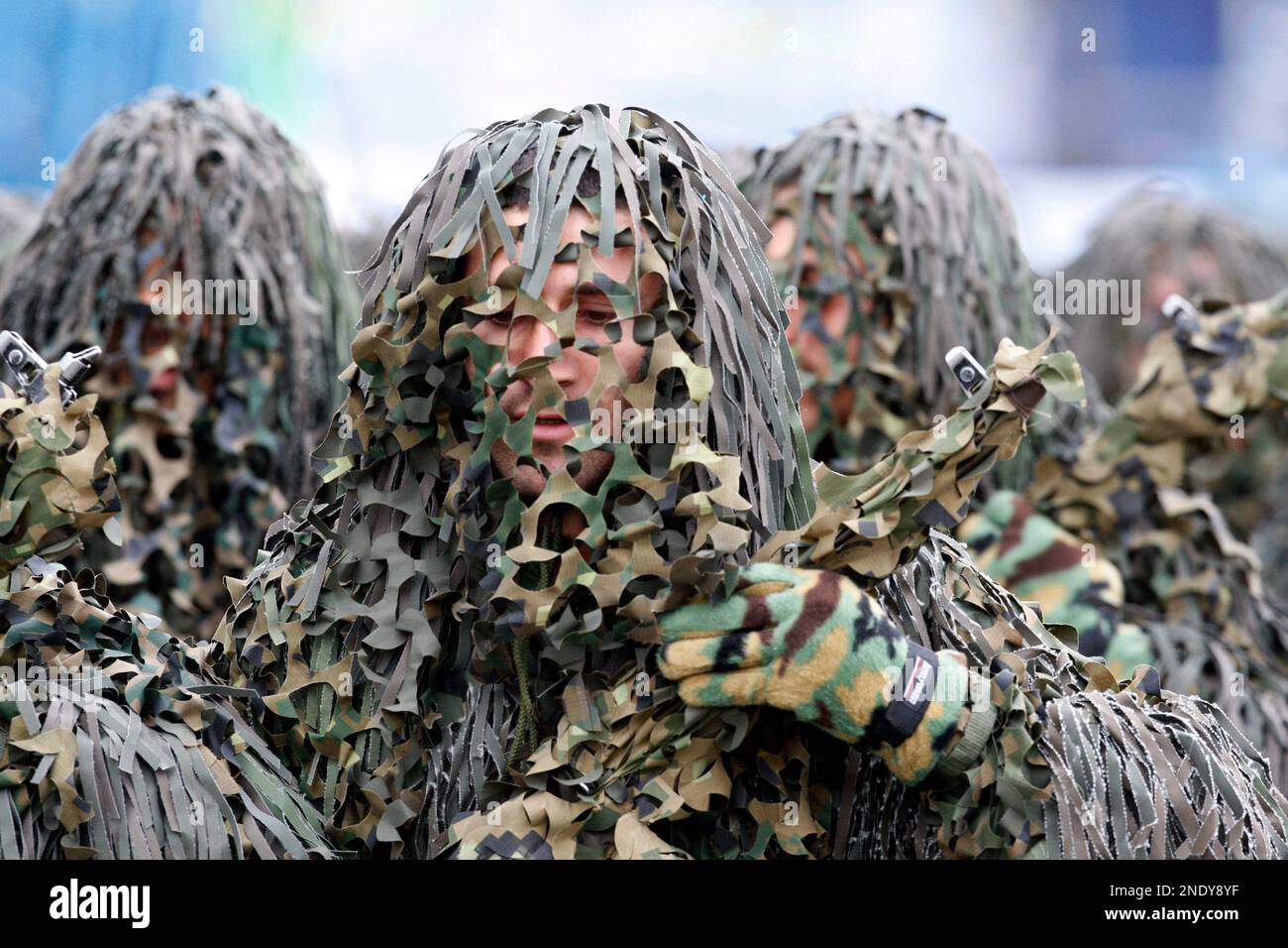 Wearing ghilli suits, Iranian army soldiers march during a parade marking National Army Day, in ...