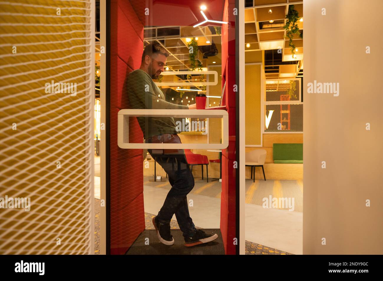 A bearded man in a booth for online negotiations. Privacy booth Stock ...