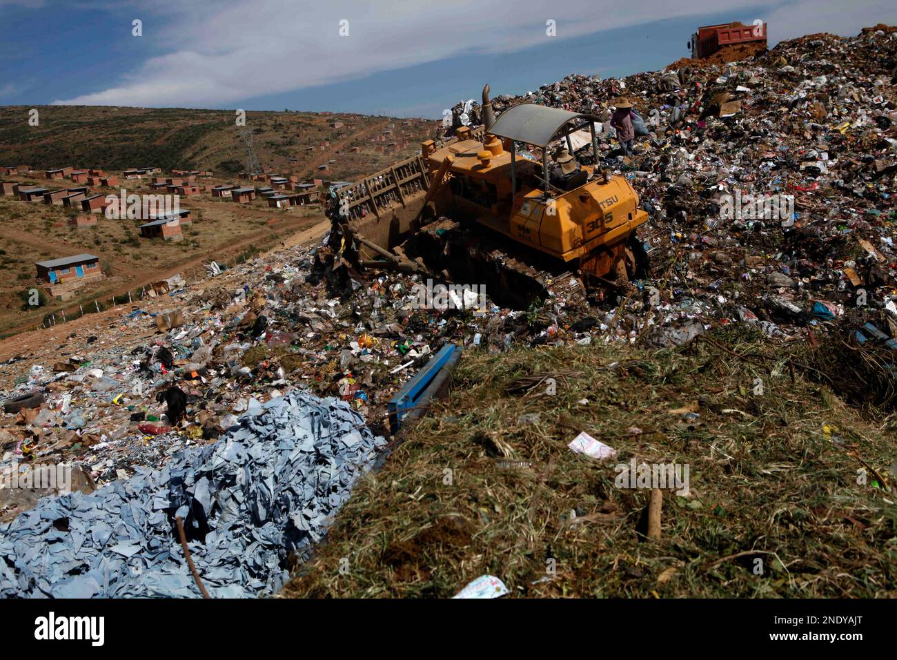 A bulldozer piles up garbage at the Kara Kara garbage dump in the ...