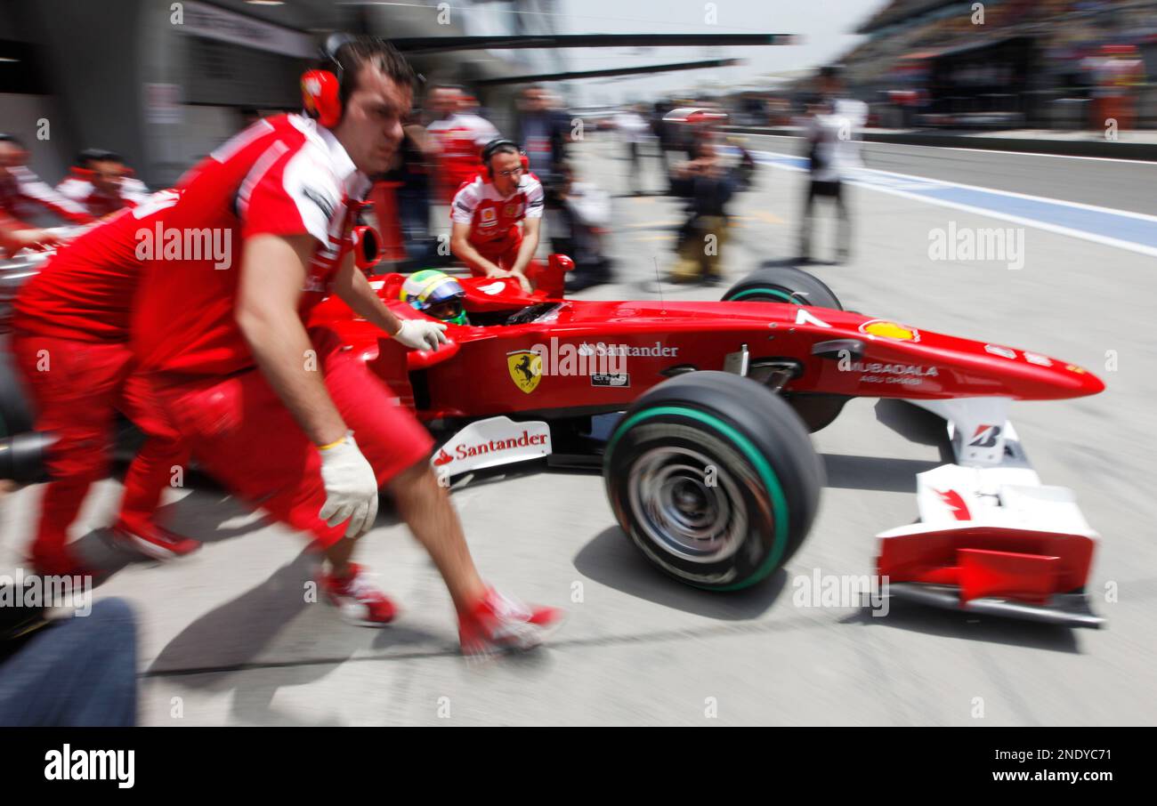 Ferrari mechanics push Formula One driver Felipe Massa's of Brazil out ...