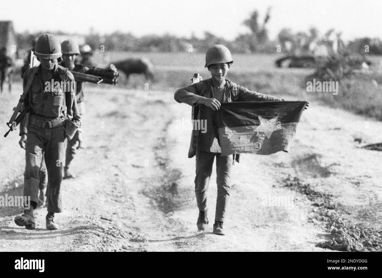 A South Vietnamese soldier displays a Viet Cong flag captured in ...