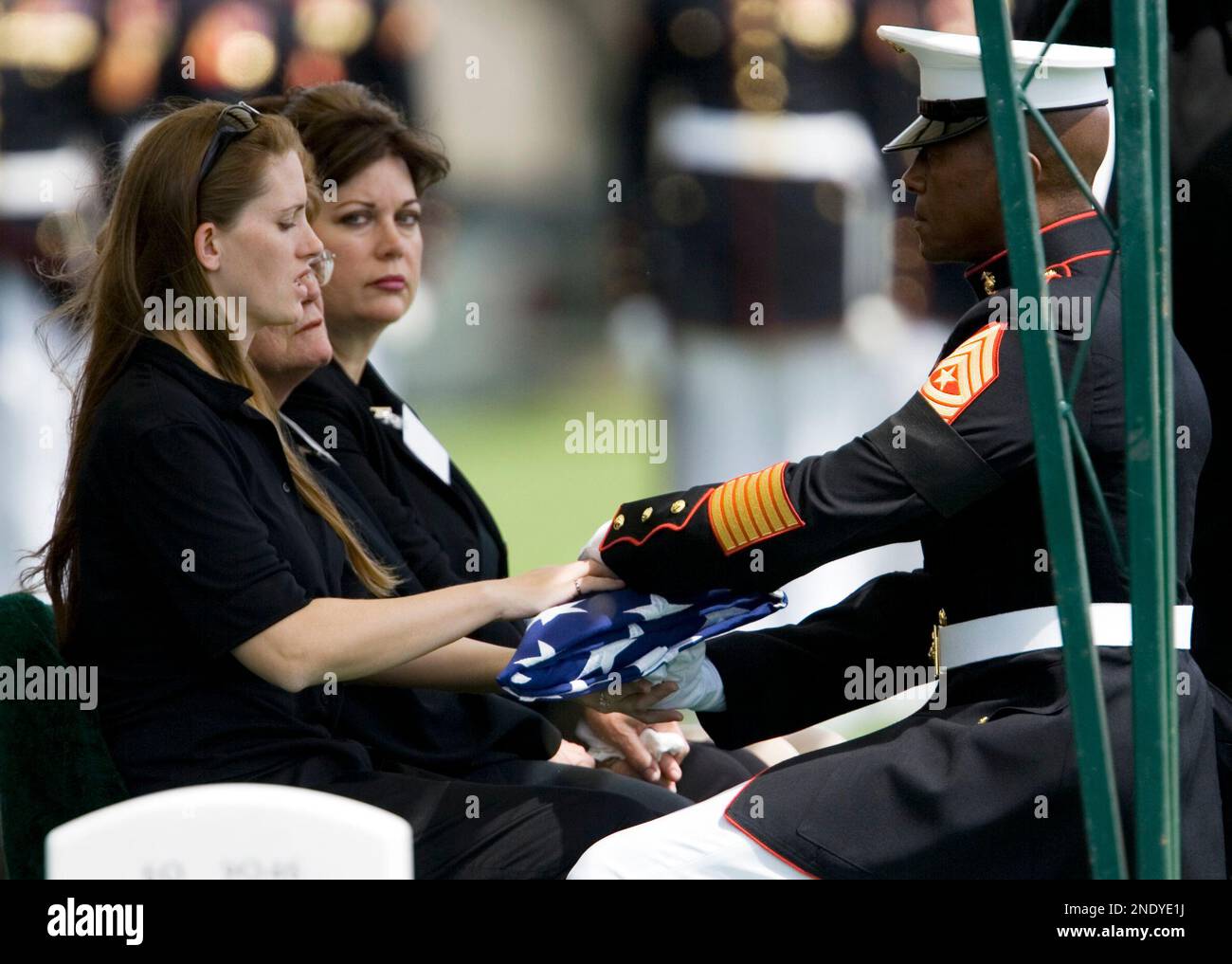 Frances Emily Cottle, left, is handed the American flag that draped her ...