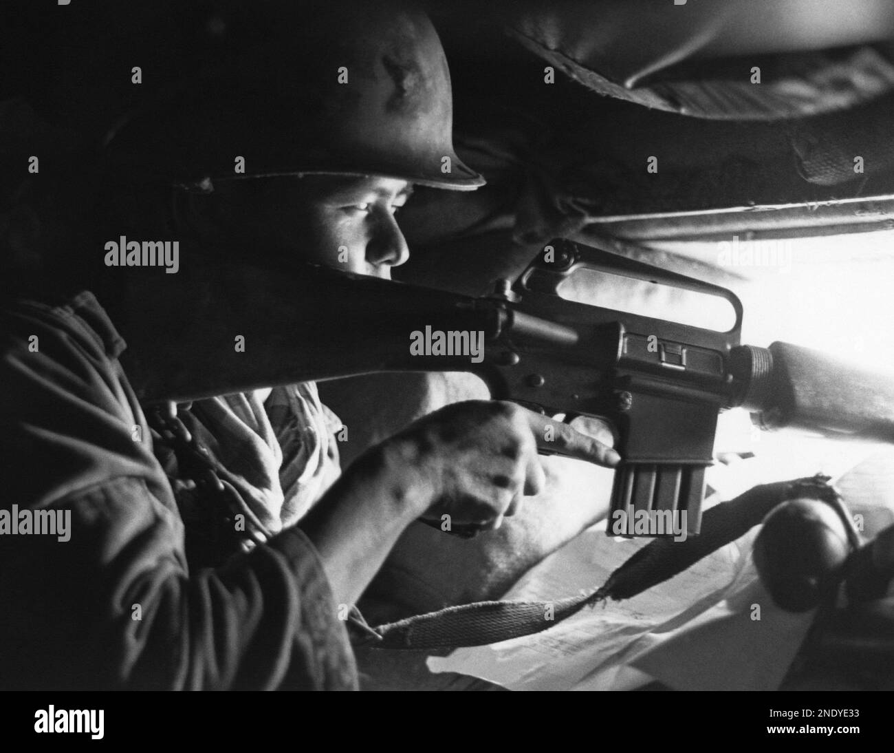 A South Vietnamese soldier looks through sights of his M16 rifle before ...