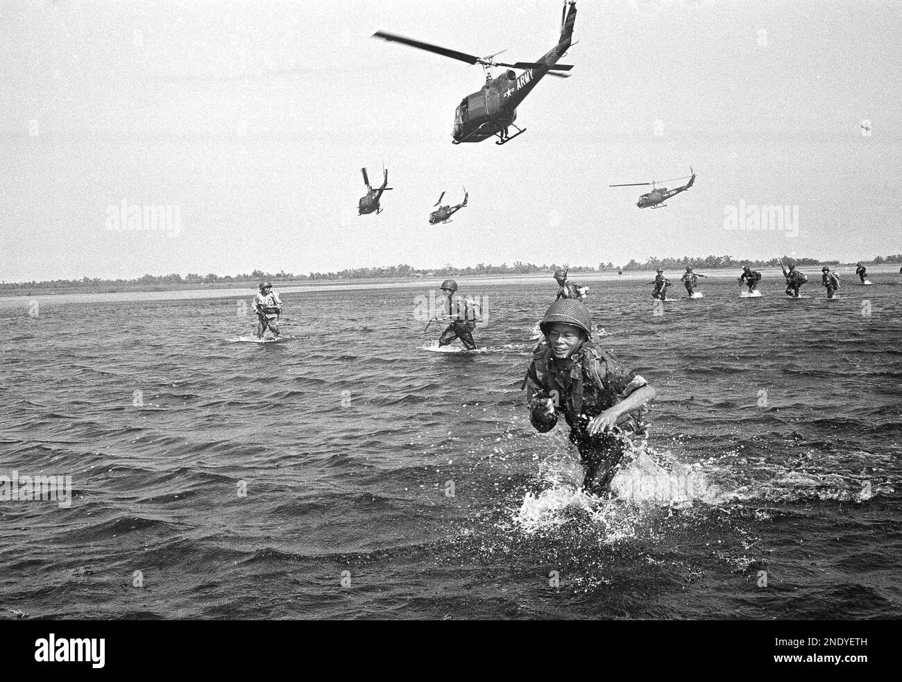 One trooper sprawls in the flooded swamp as other Vietnamese Government ...