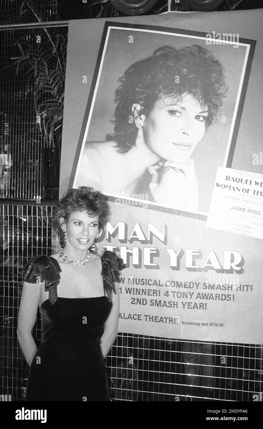 Raquel Welch poses in front of poster for "Woman of the Year" at party ...