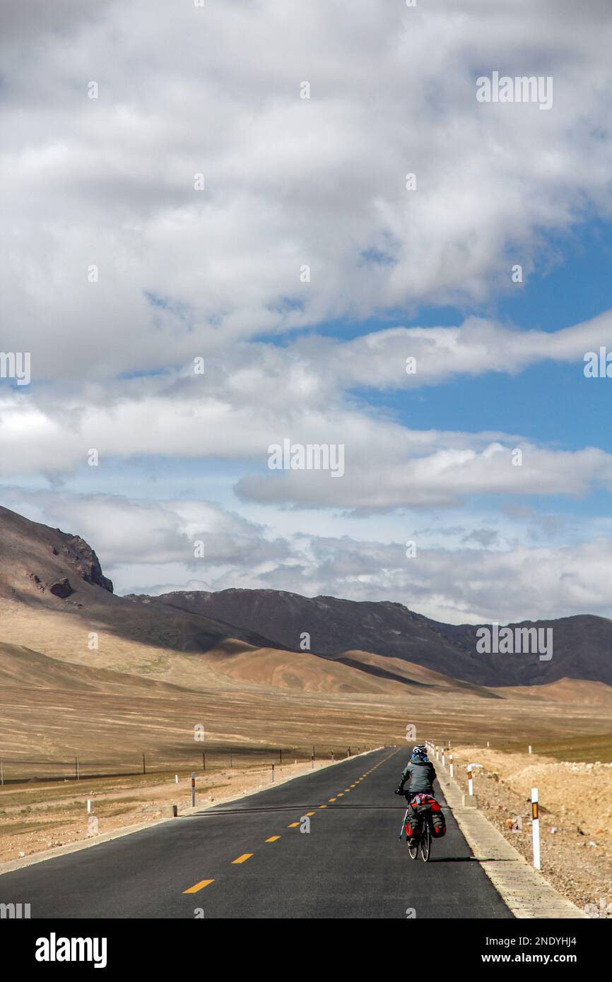 An aerial view of road through desert surrounded by hills Stock Photo ...