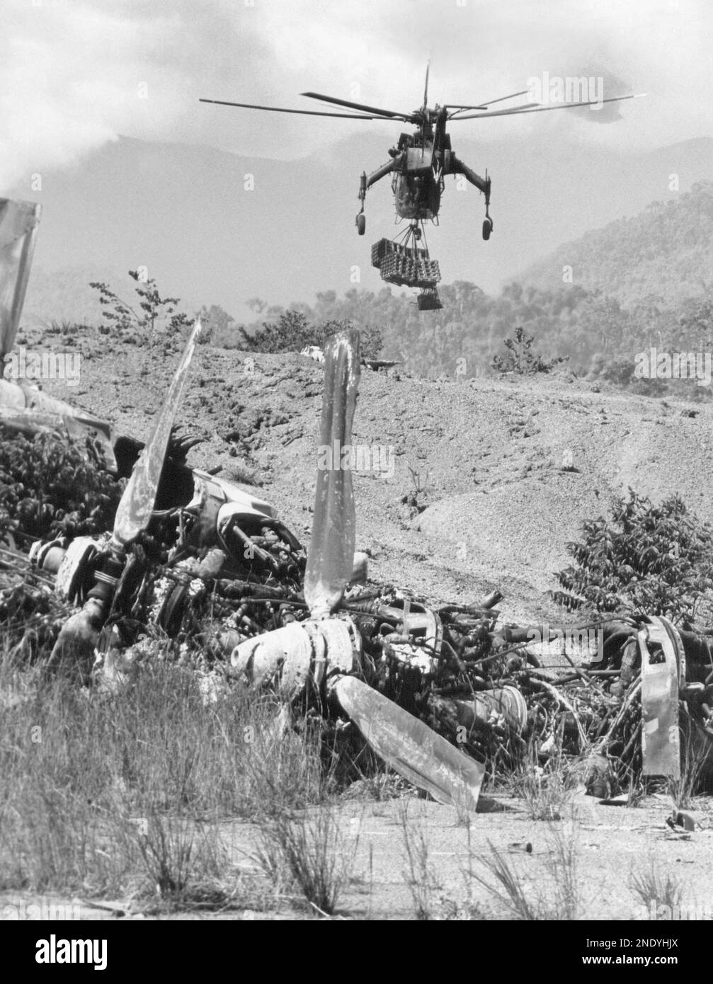 A U.S. Army helicopter brings in a load of supplies to the newly ...