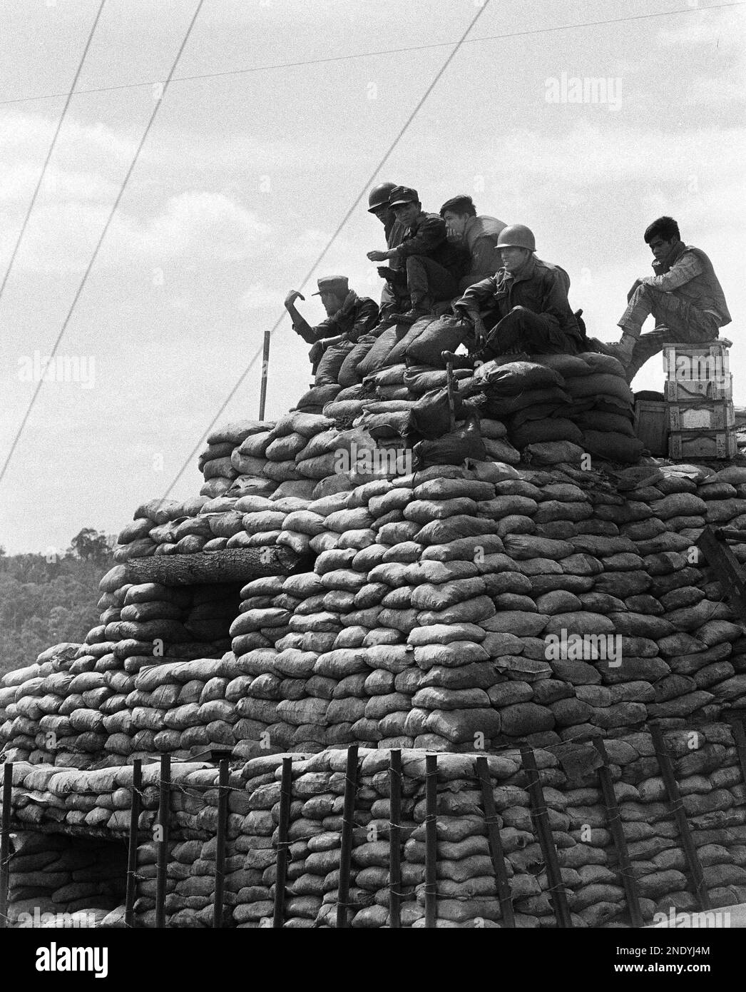 South Vietnamese Infantriemen sit on tpr of a pyramid shaped fortified ...