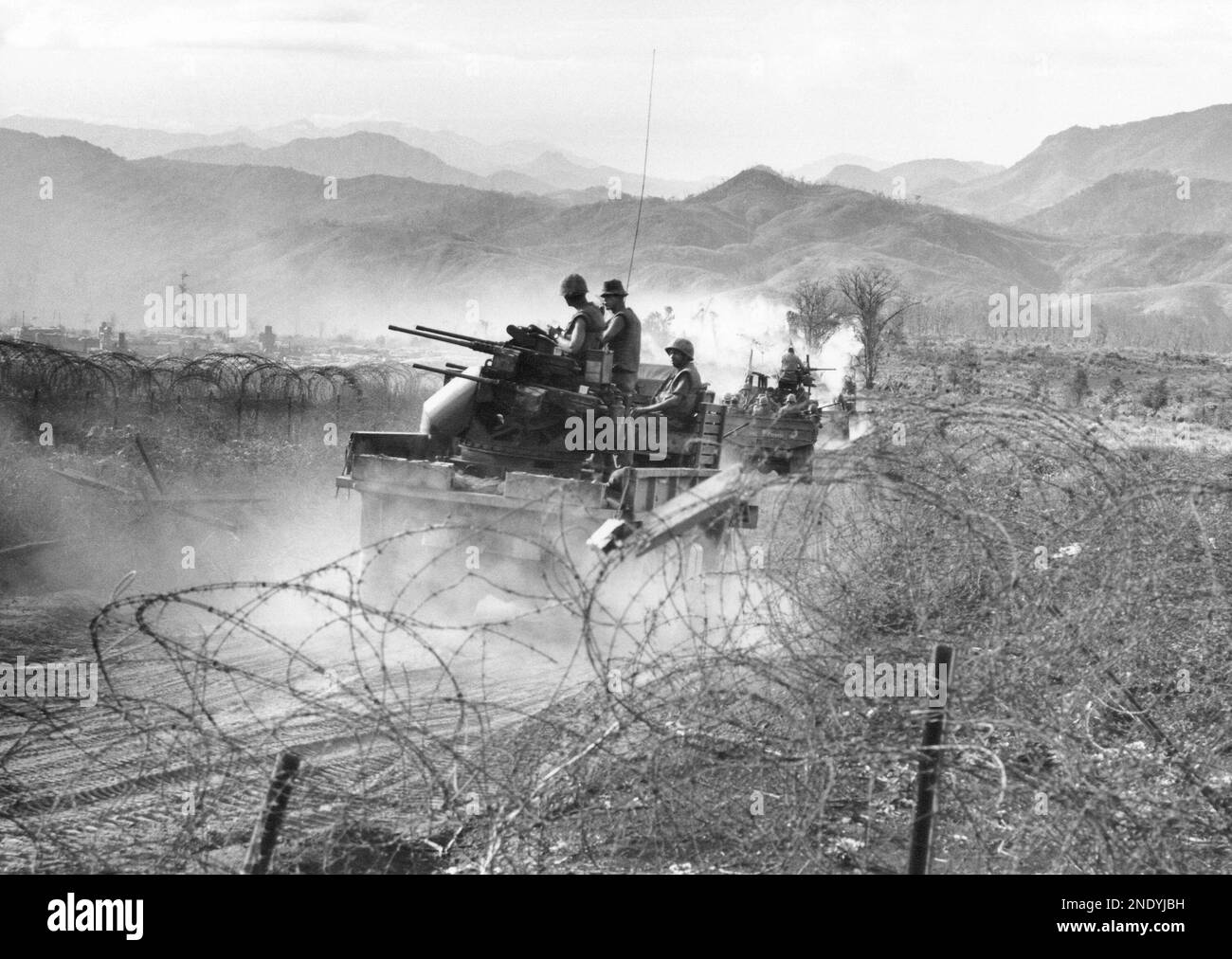 An armed convoy leaves the Khe Sanh combat base with a cargo of varied ...