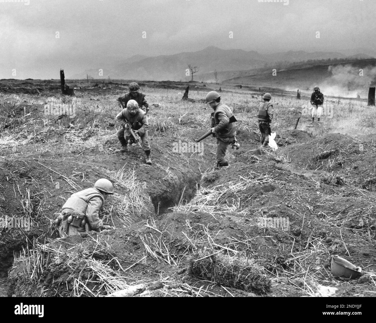 South Vietnamese rangers advance on a North Vietnamese trench outside ...