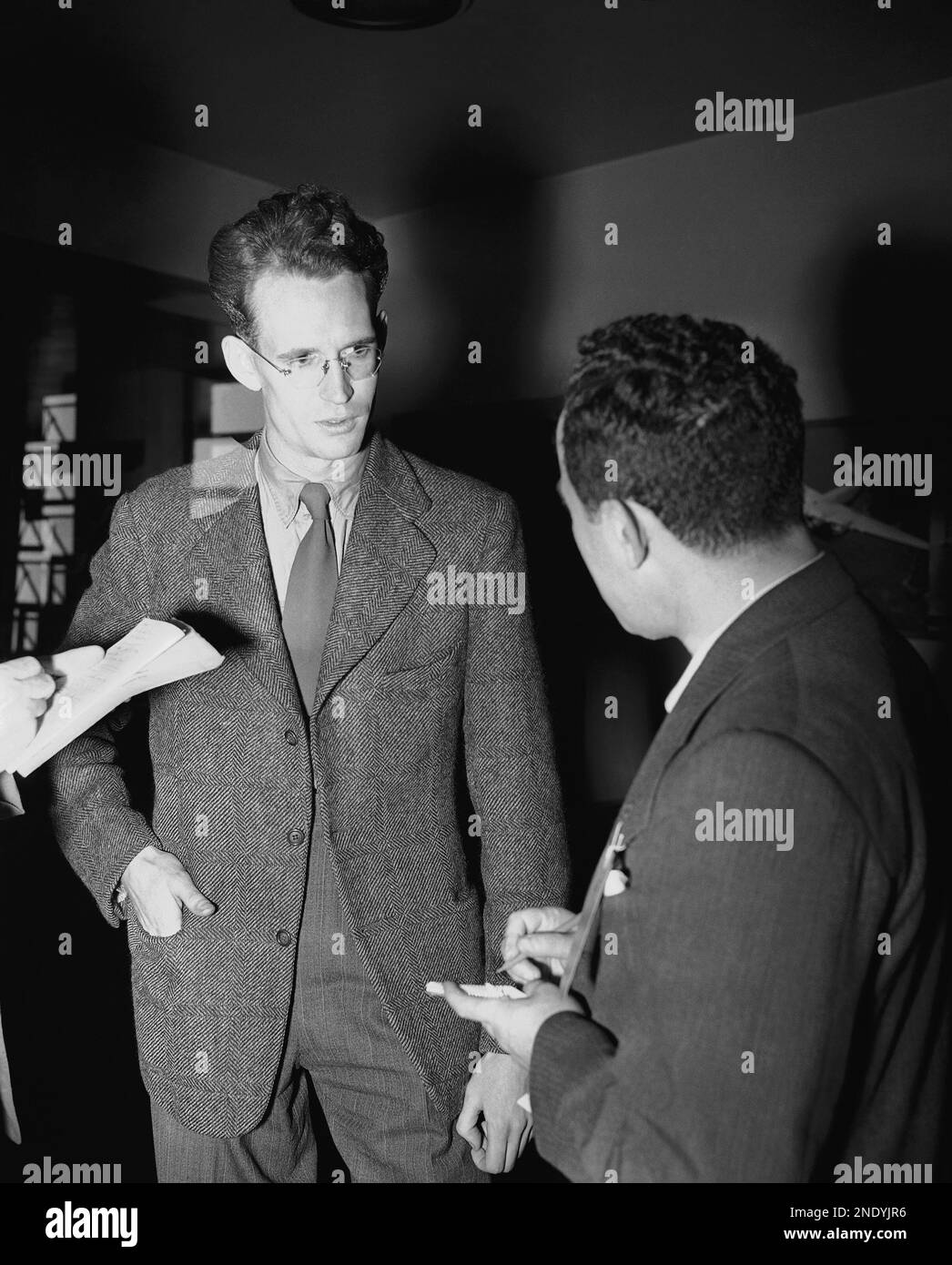 Ross Munro of Canadian press staffer, talking to reporters at La ...