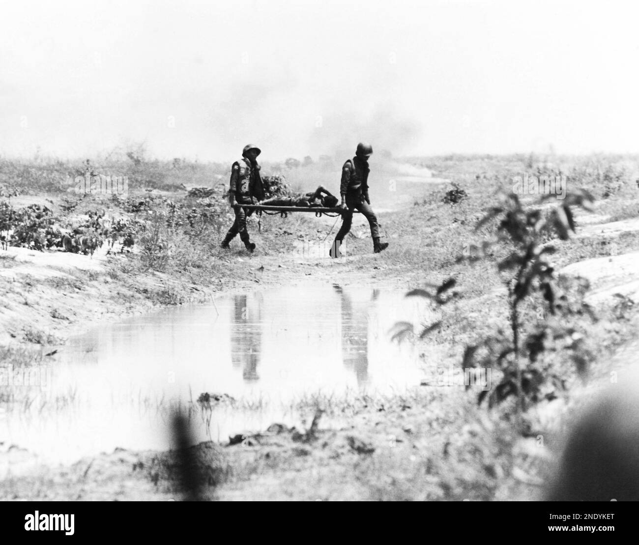 A wounded South Vietnamese soldier is carried to an evacuation point on ...