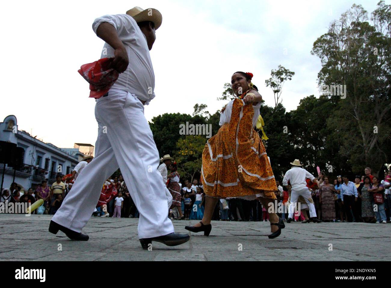 Two dancers circle each other while performing a traditional Mexican ...