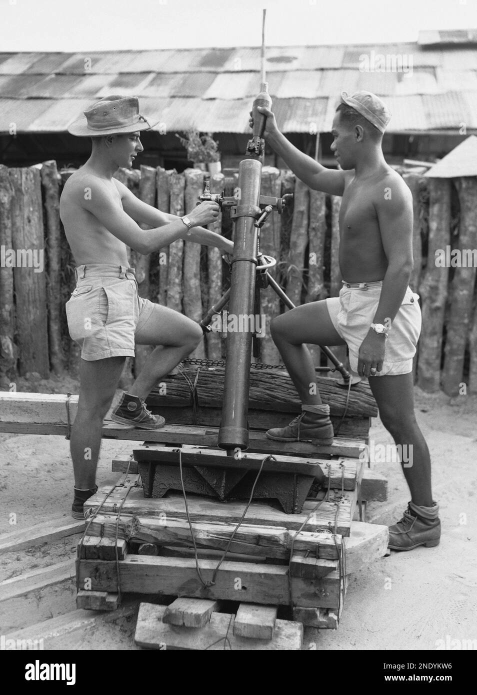 Sgt. Rolland Fournier and Manu Taviraris arm an 81 millimeter mortar in ...
