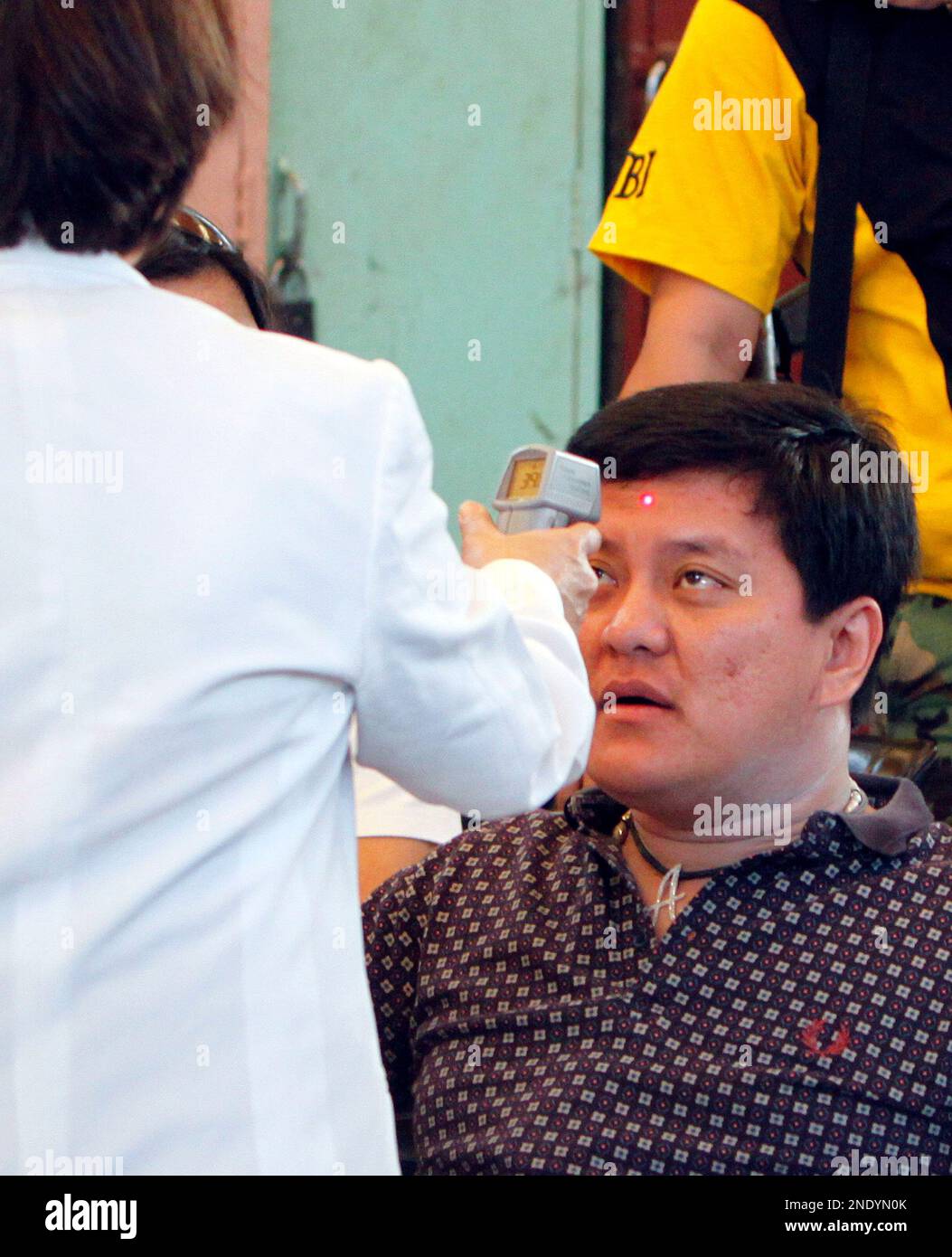 A doctor takes the temperature of Andal Ampatuan Jr., a scion of a ...