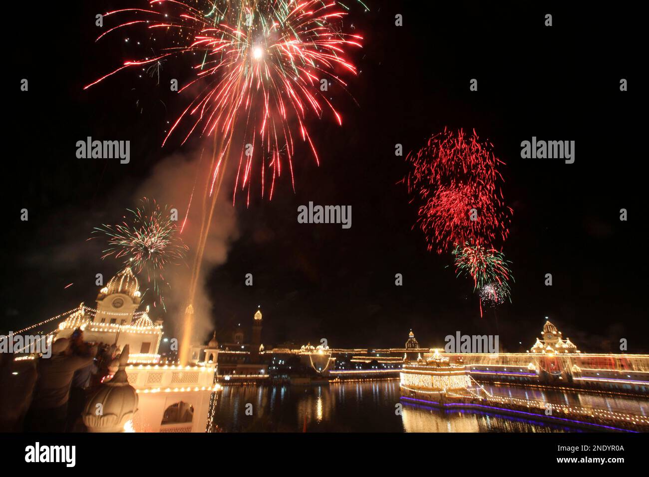 Fireworks are seen over the illuminated Golden Temple, the Sikhs ...
