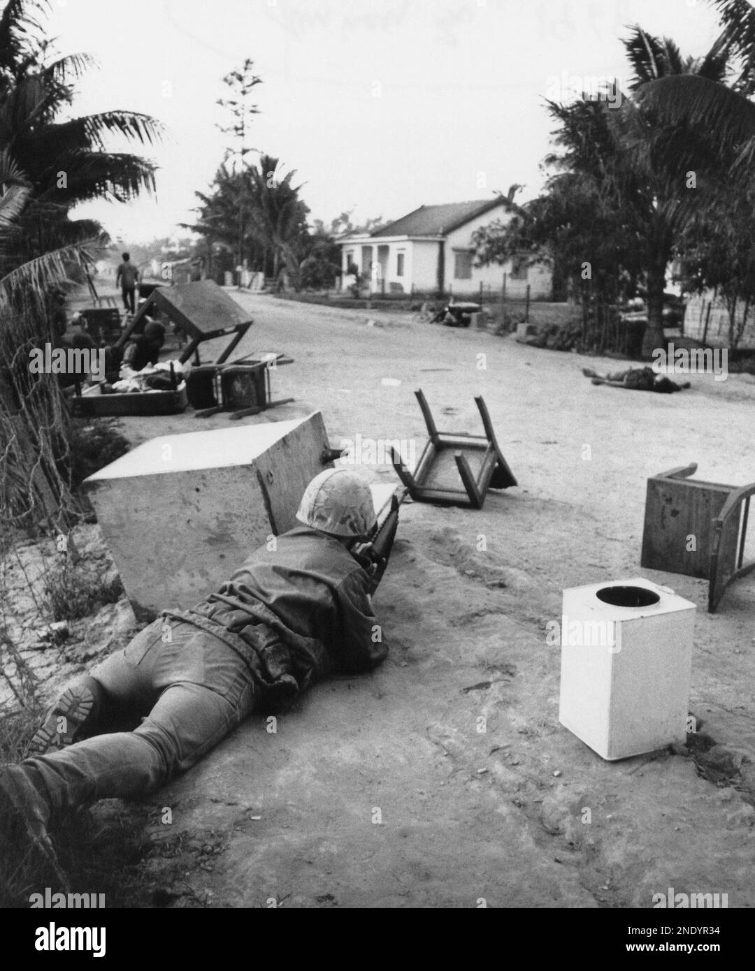 A South Vietnamese soldier fires from behind a barricade in a Da Nang ...