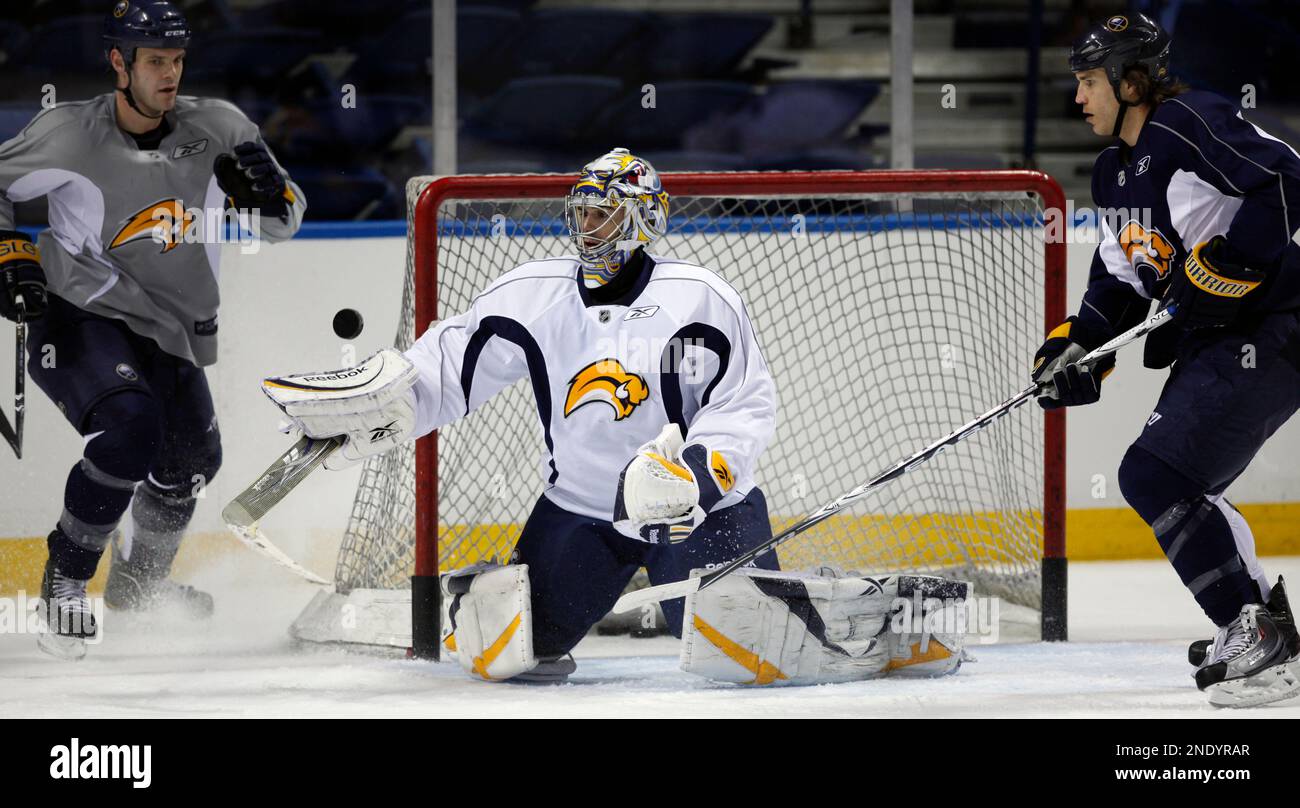 Buffalo Sabres' Ryan Miller makes a save under pressure from Paul ...