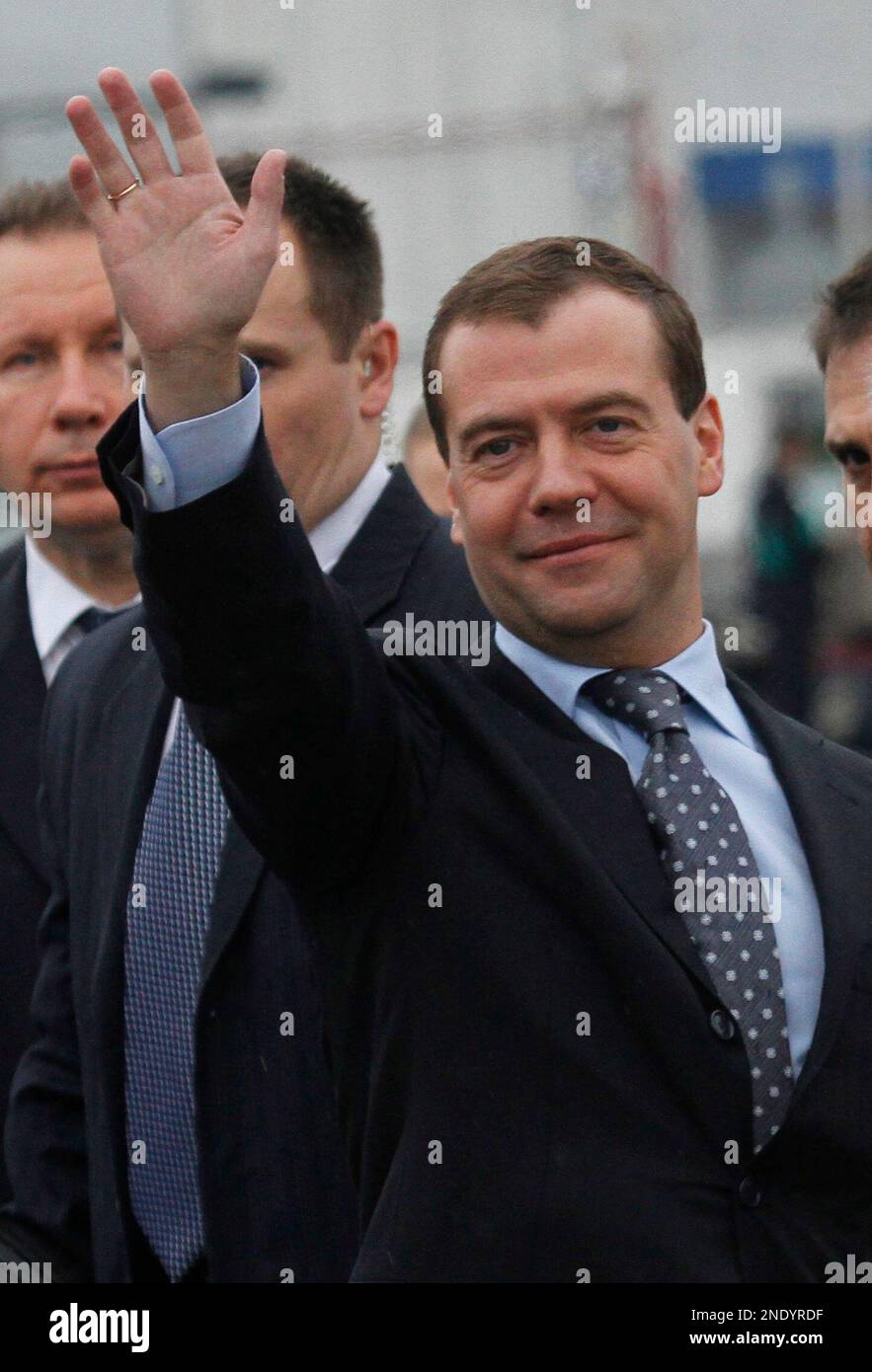Russias President Dmitry Medvedev Waves To Reporters Upon Arrival To