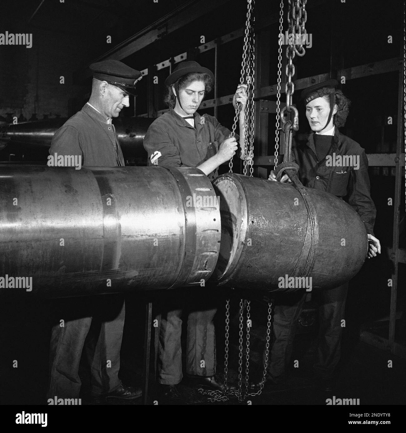 At work on the torpedo head is Wren Joyce Taylor, centre, during a ...